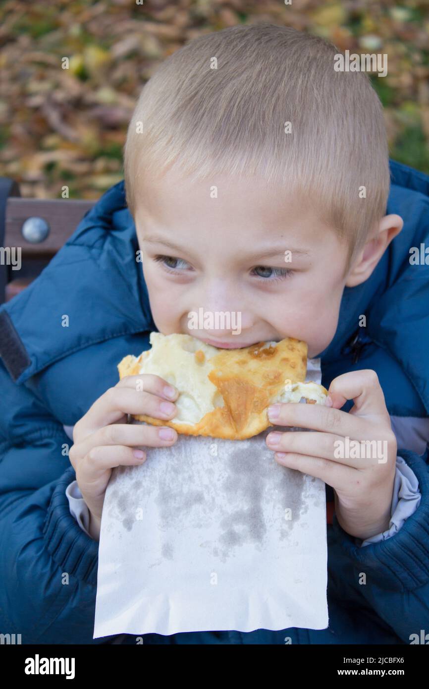 autumn boy biting delicious pastries teeth Boy biting food Stock Photo ...