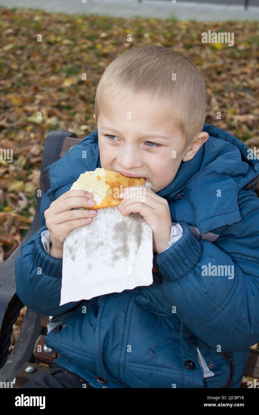 Boy eating unhealthy food hi-res stock photography and images - Alamy