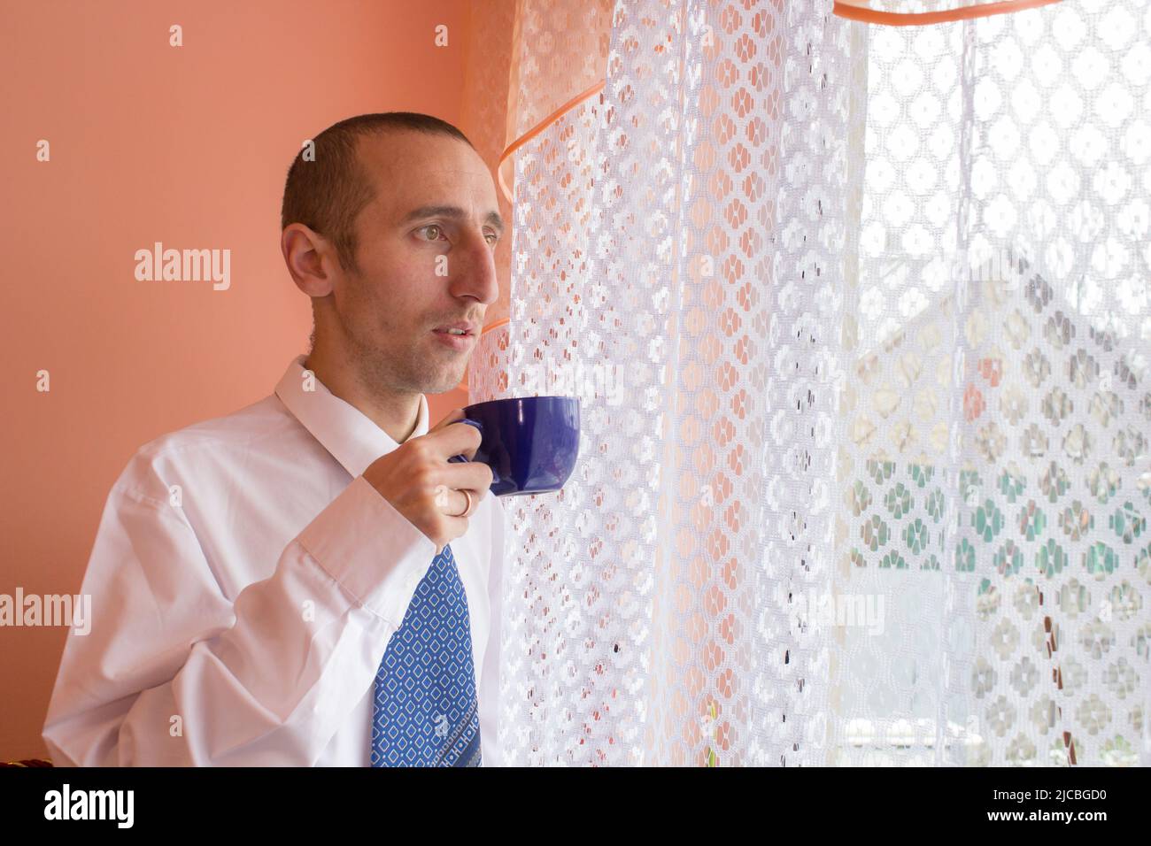 lunch break businessman drinking coffee by the window Stock Photo - Alamy