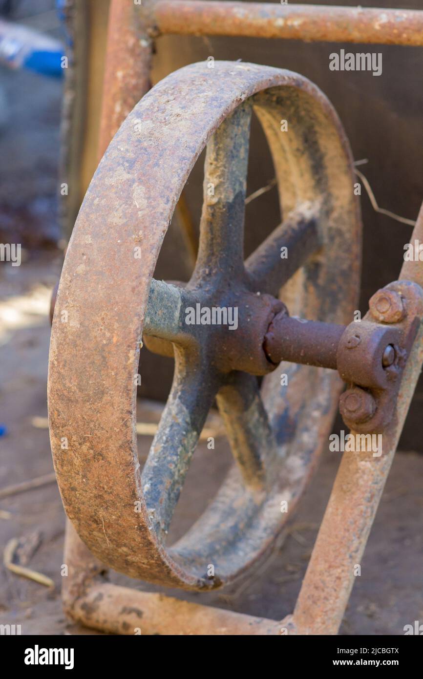 wheel close-up of rust iron fixed on a wheelbarrow Stock Photo - Alamy