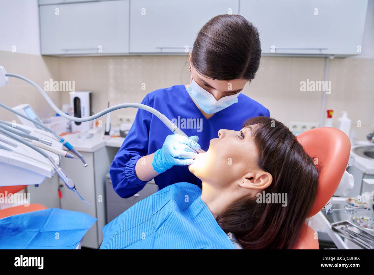 Woman patient treating teeth in clinic, treatment process Stock Photo ...