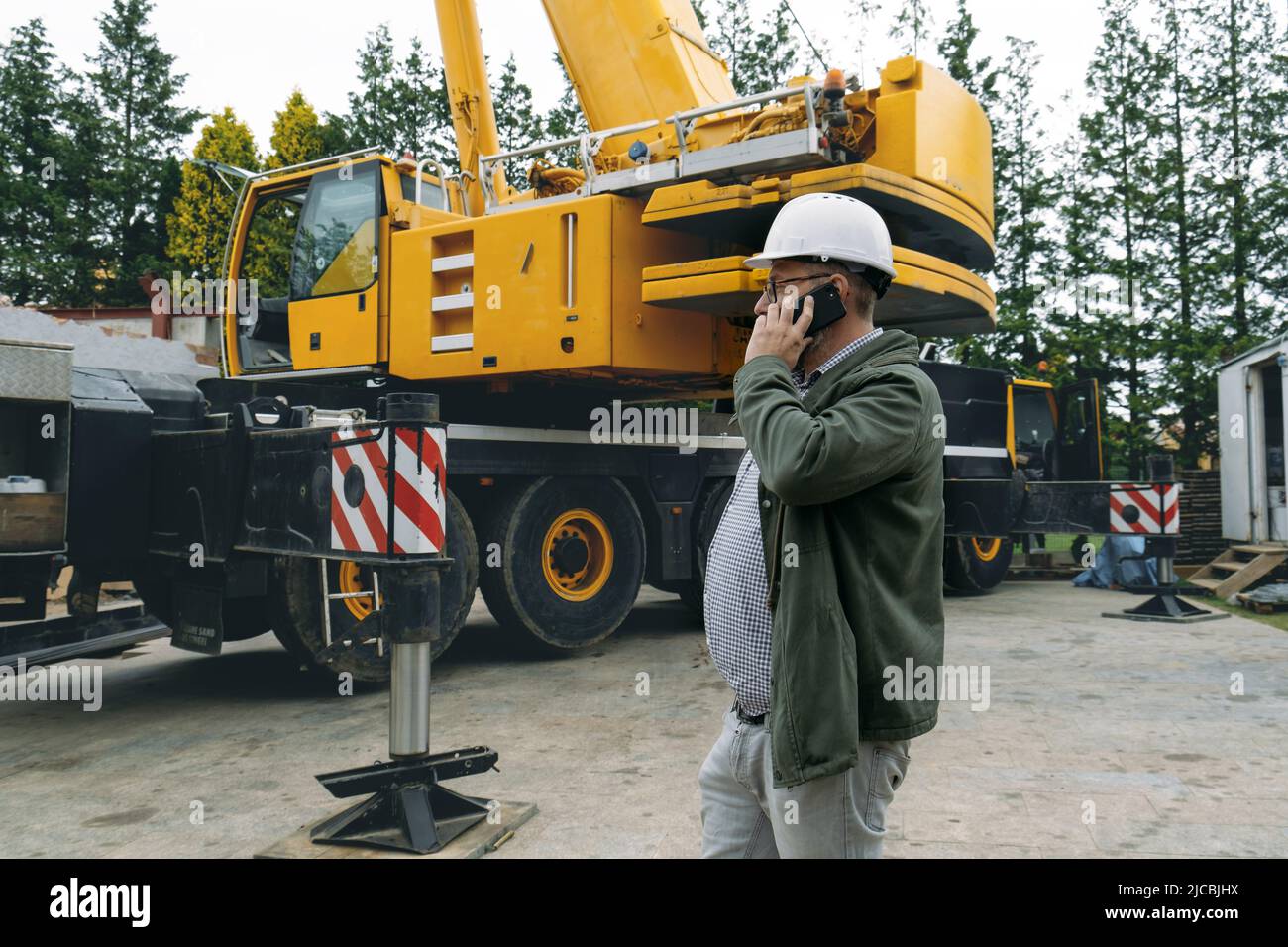 Foreman talking by phone on construction site. architect discussing ...
