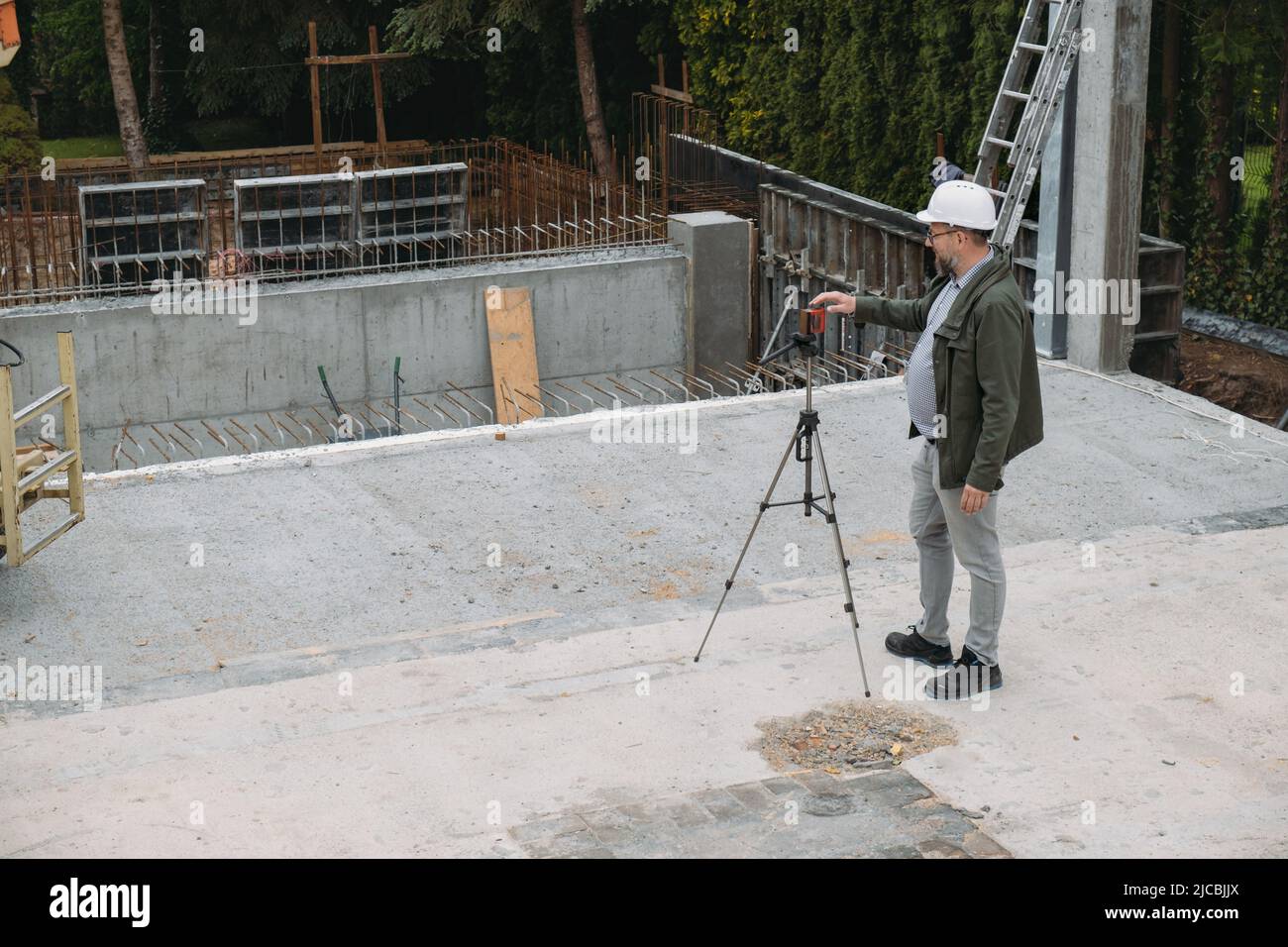 Geodetic works. Surveyor engineer using geodetic equipment at ...