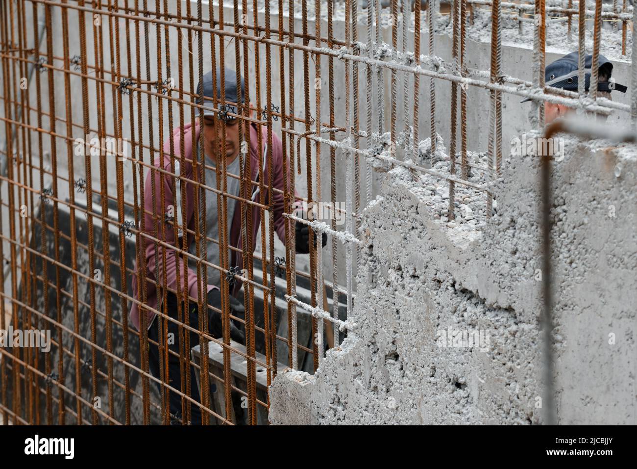 Construction of a concrete wall with reinforcement. Private house ...