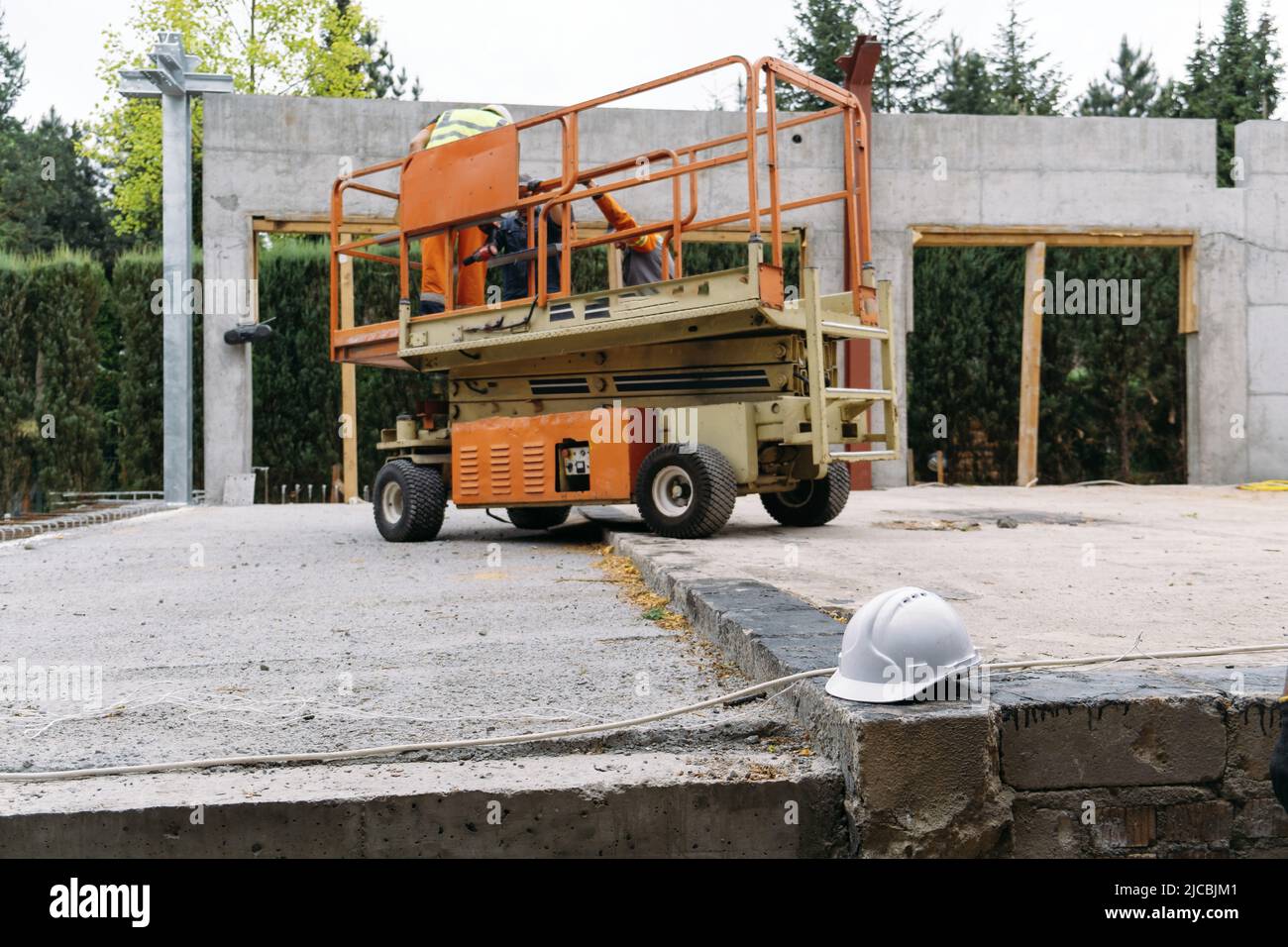Scissor Lift Platform on a construction site. Building concreate house ...