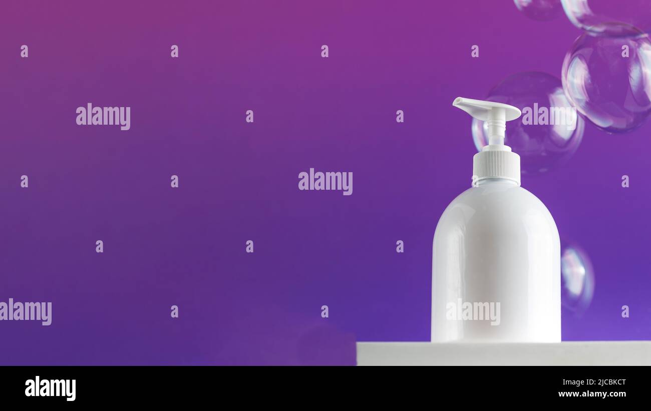 Mockup of a white dispenser with a cosmetic product on a purple ...