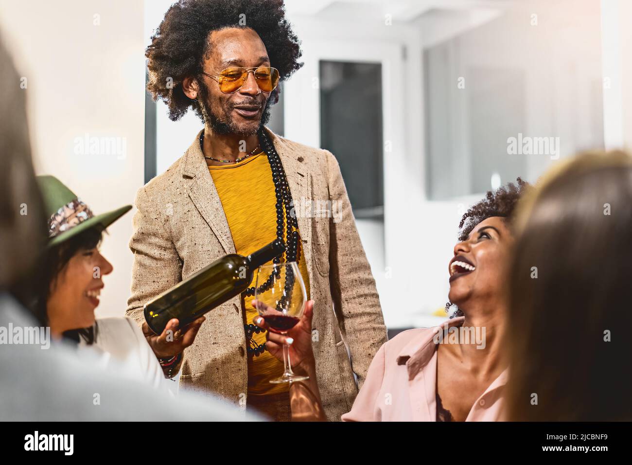 Multi-ethnic community of adult people having a dinner party Stock ...