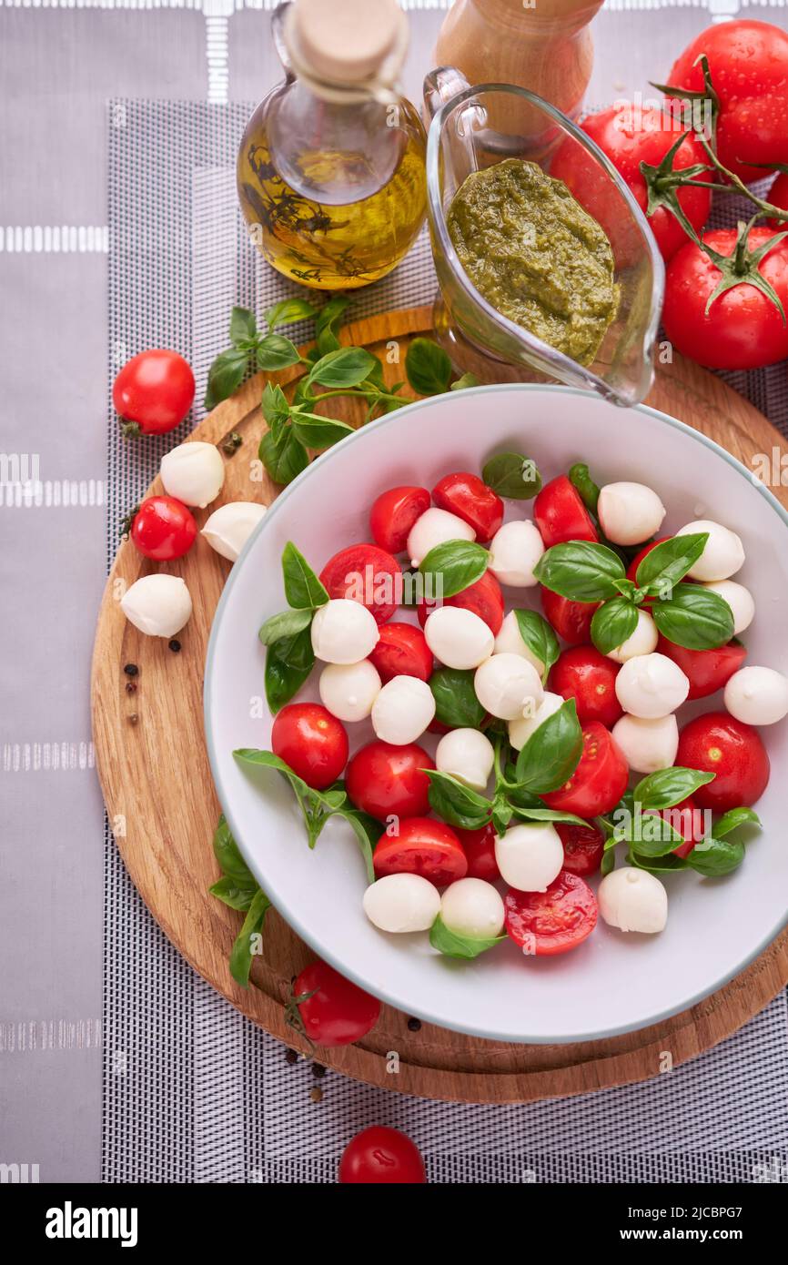 Caprese salad - Mini mozzarella cheese in glass bowl, tomato and basil ...