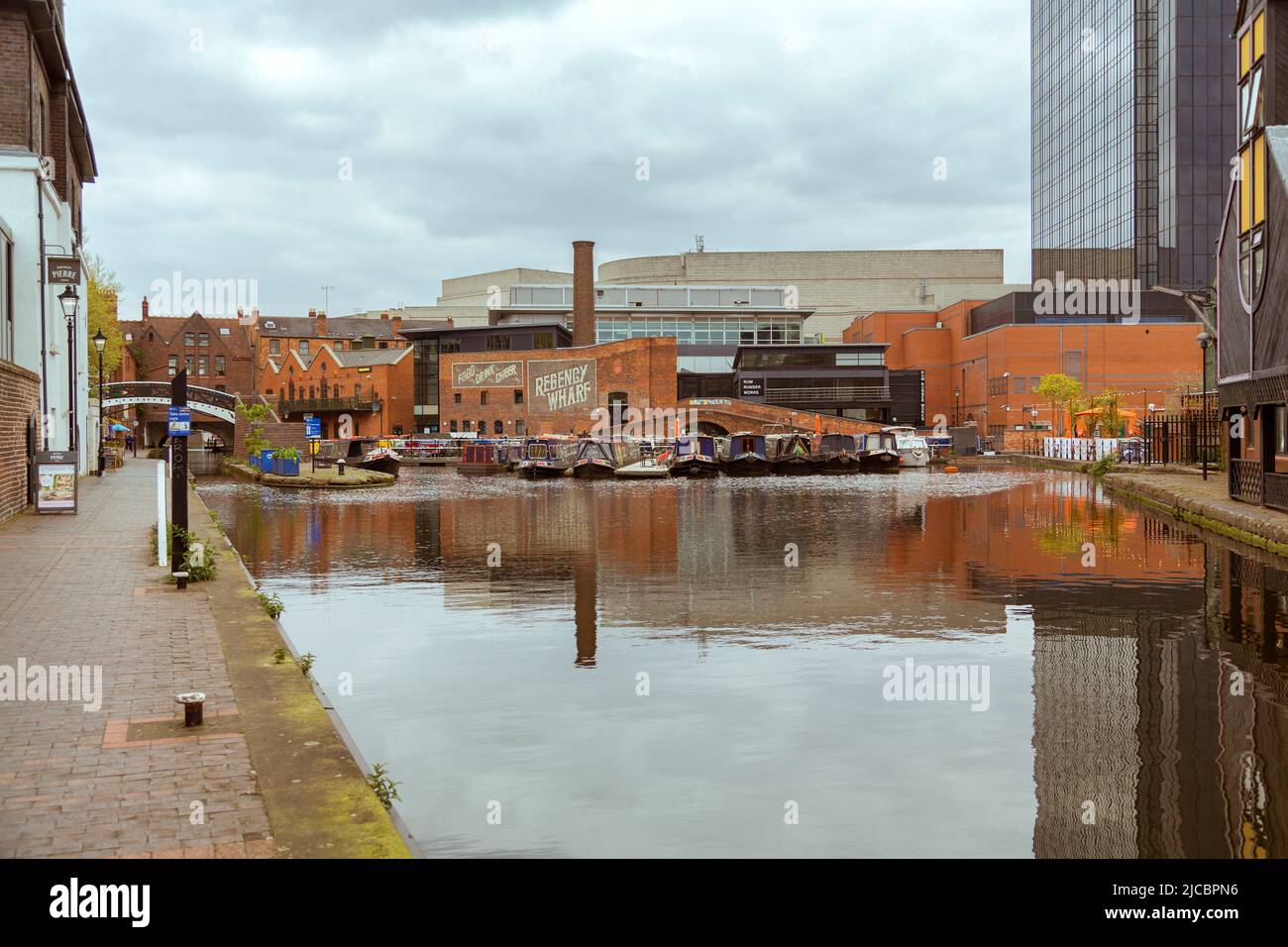 Houseboats lined up on the canal at Regency Wharf, surrounded by the ...