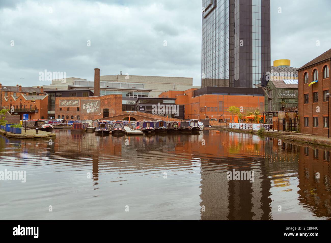 Houseboats lined up on the canal at Regency Wharf, surrounded by the ...