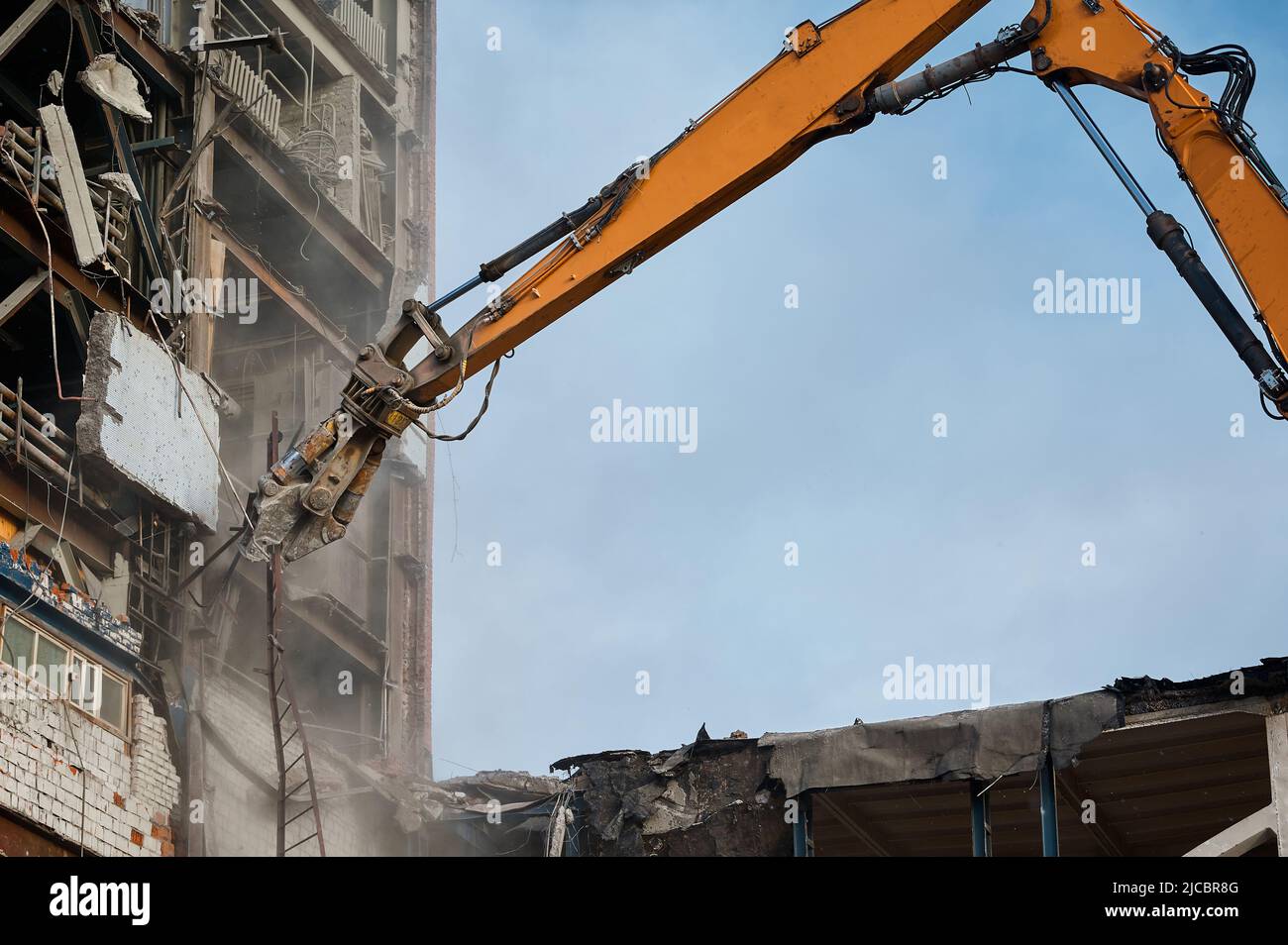 Hydraulic scissors on rig of crane cut building on site Stock Photo - Alamy