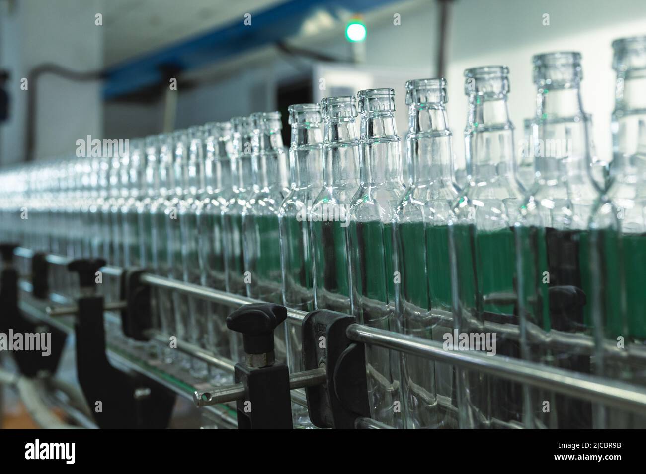 Production line transports empty glass bottles for alcohol Stock Photo ...