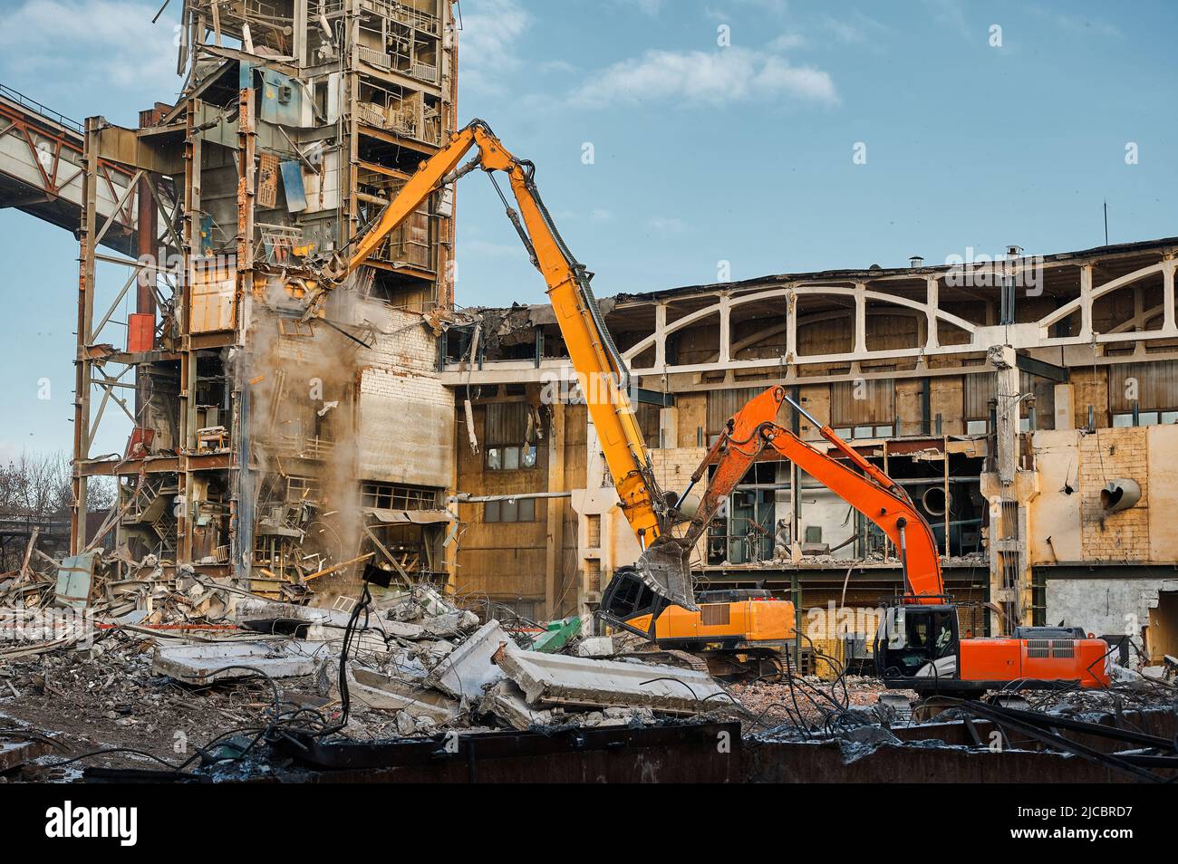 Hydraulic excavator removes concrete beam at demolition site Stock ...