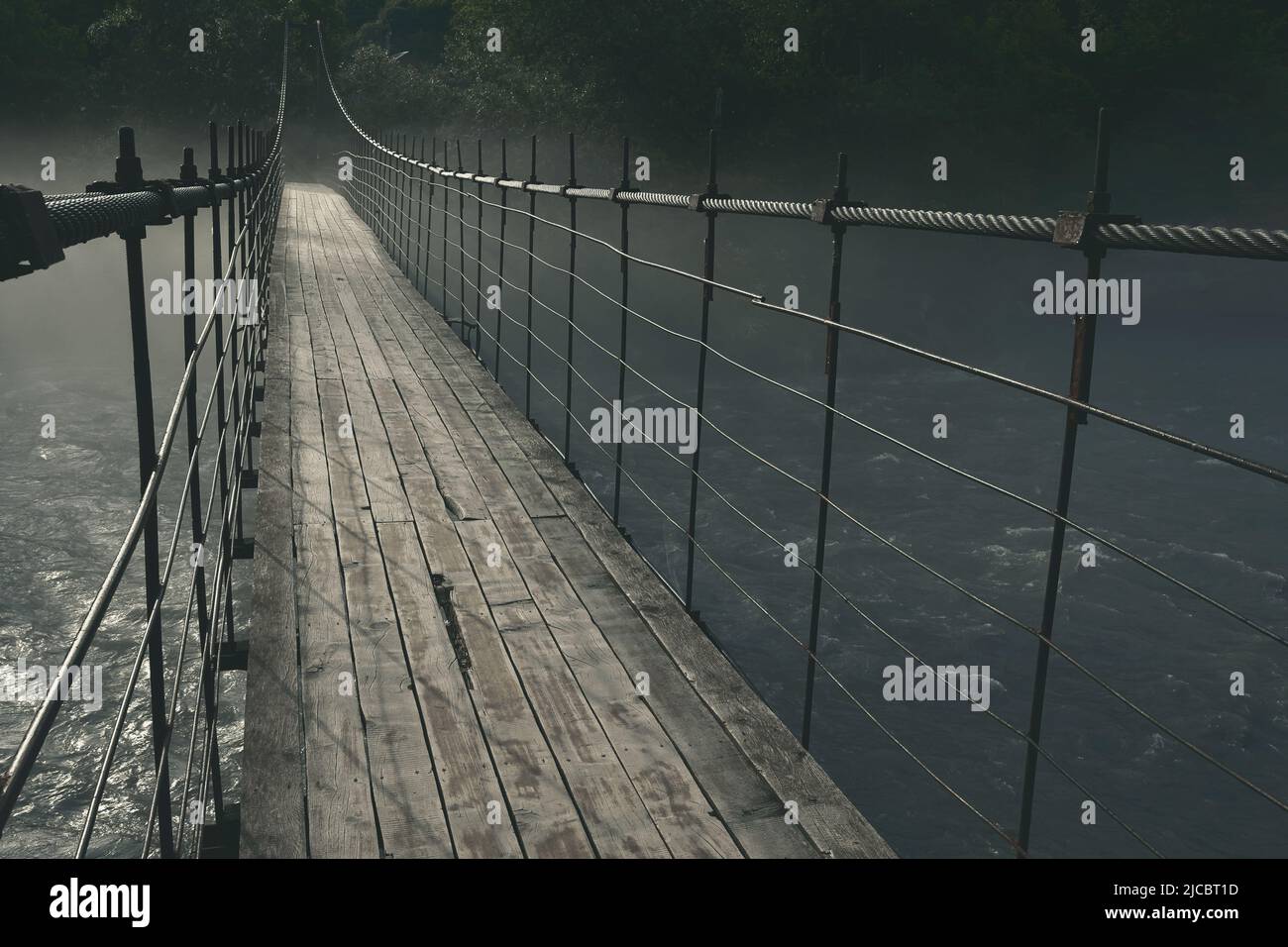 old wooden long suspension bridge over the Belaya mountain river, in ...