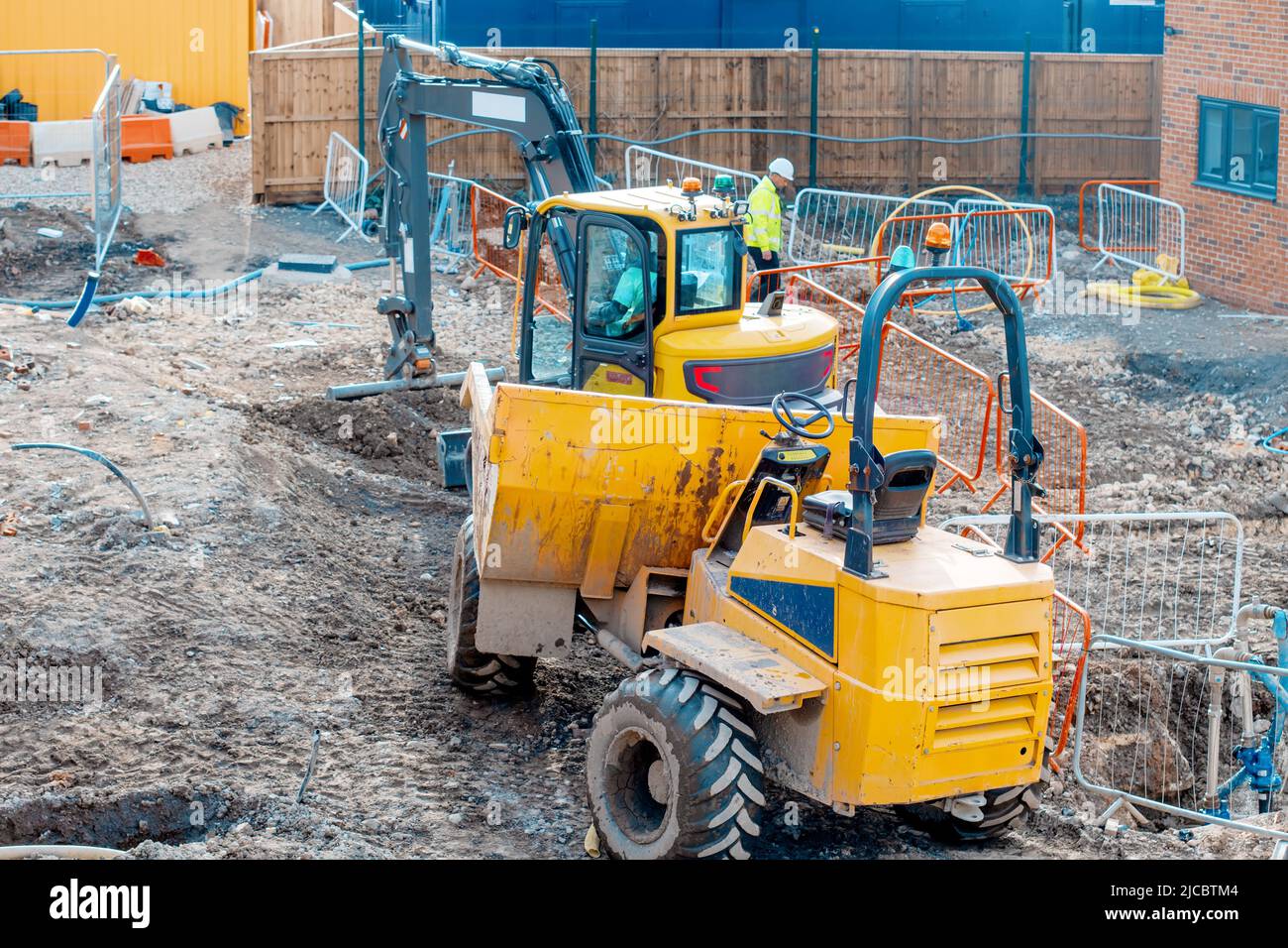 Construction plant and machinery. Dumper and excavator working on new ...
