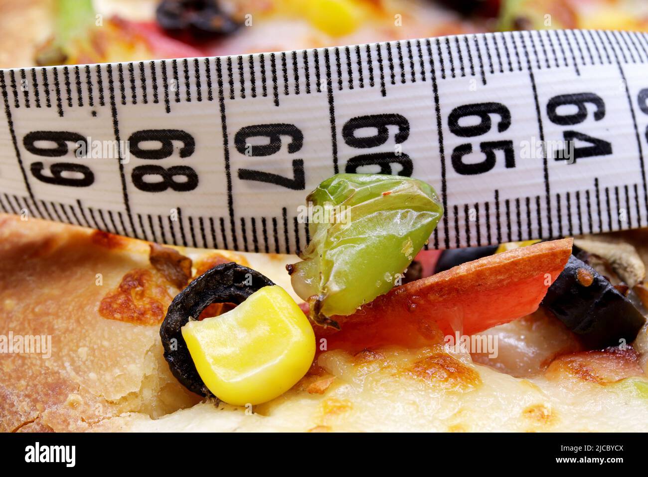 Close-up pizza with measuring tape Stock Photo - Alamy
