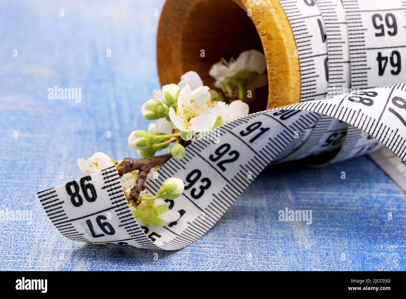 Concept with measuring tape and spring flowers Stock Photo - Alamy