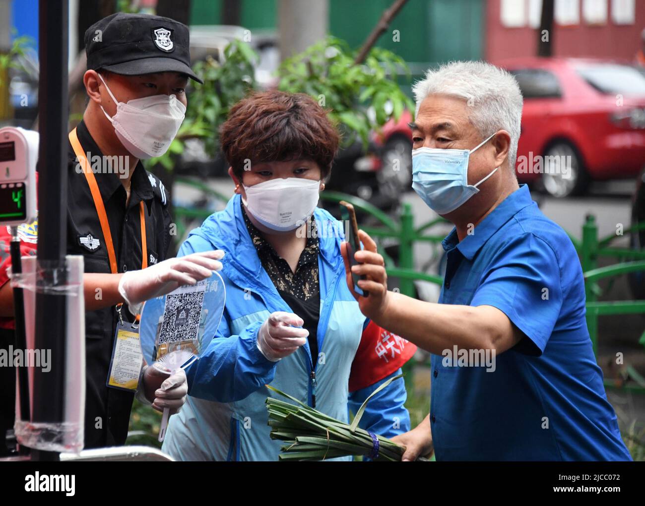 Beijing, China. 12th June, 2022. A resident scans a QR code to register ...