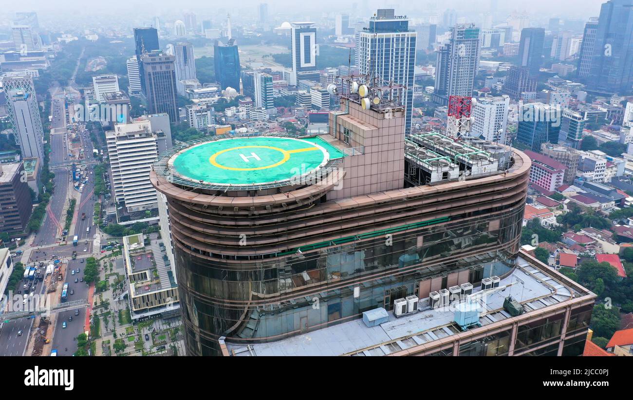 Aerial drone view of helipad on the roof of a skyscraper iin downtown ...
