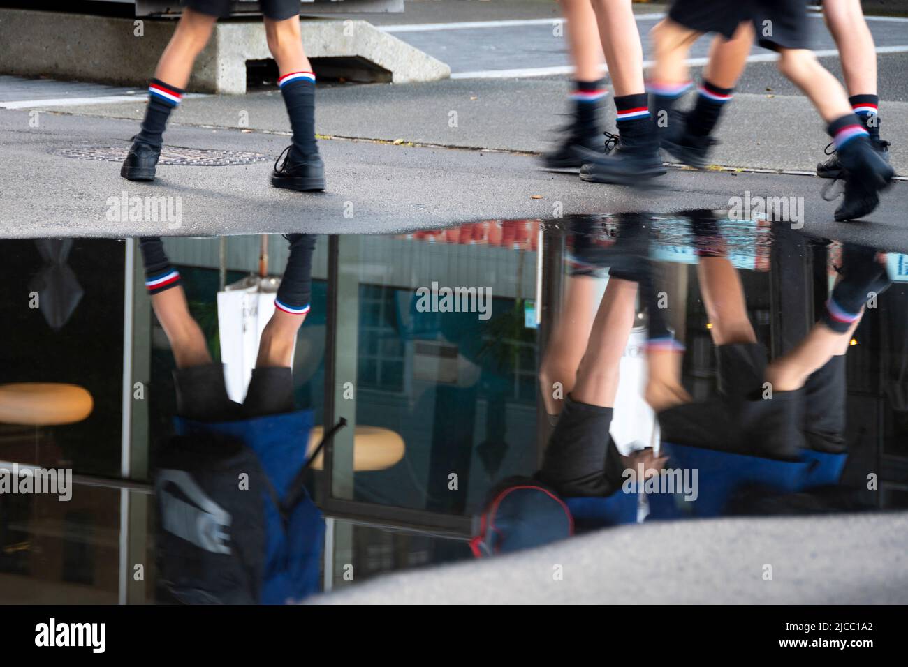 Schoolboys and puddles, Wellington, North Island, New Zealand Stock ...