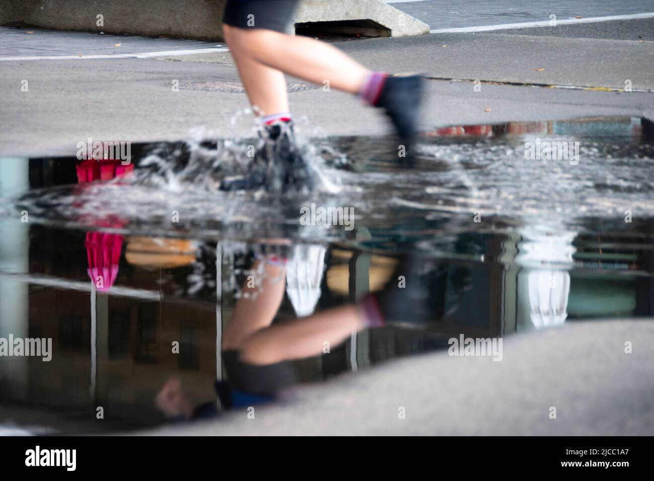 Child wading through puddle hi-res stock photography and images - Alamy
