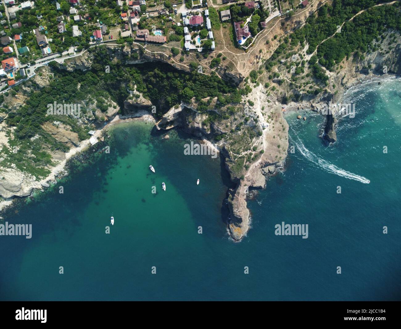 Aerial view from above on calm azure sea and volcanic rocky shores ...