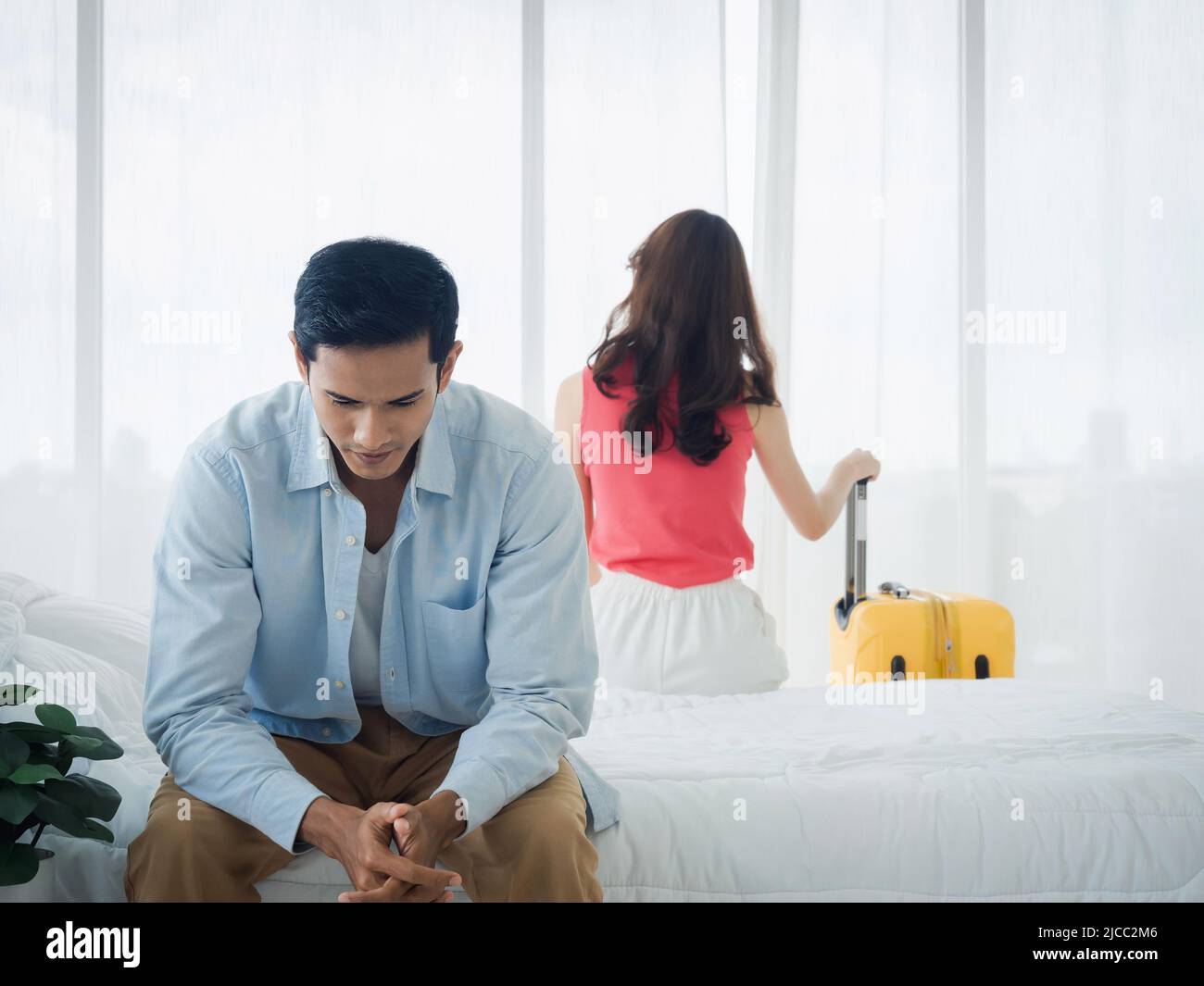 The anxiety of Asian couple lovers on the bed. Stressed man and young ...
