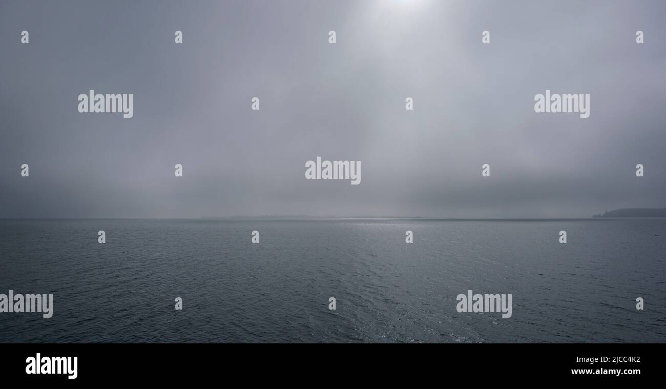 Grey blue moody calm sea with hazy diffued light Stock Photo - Alamy
