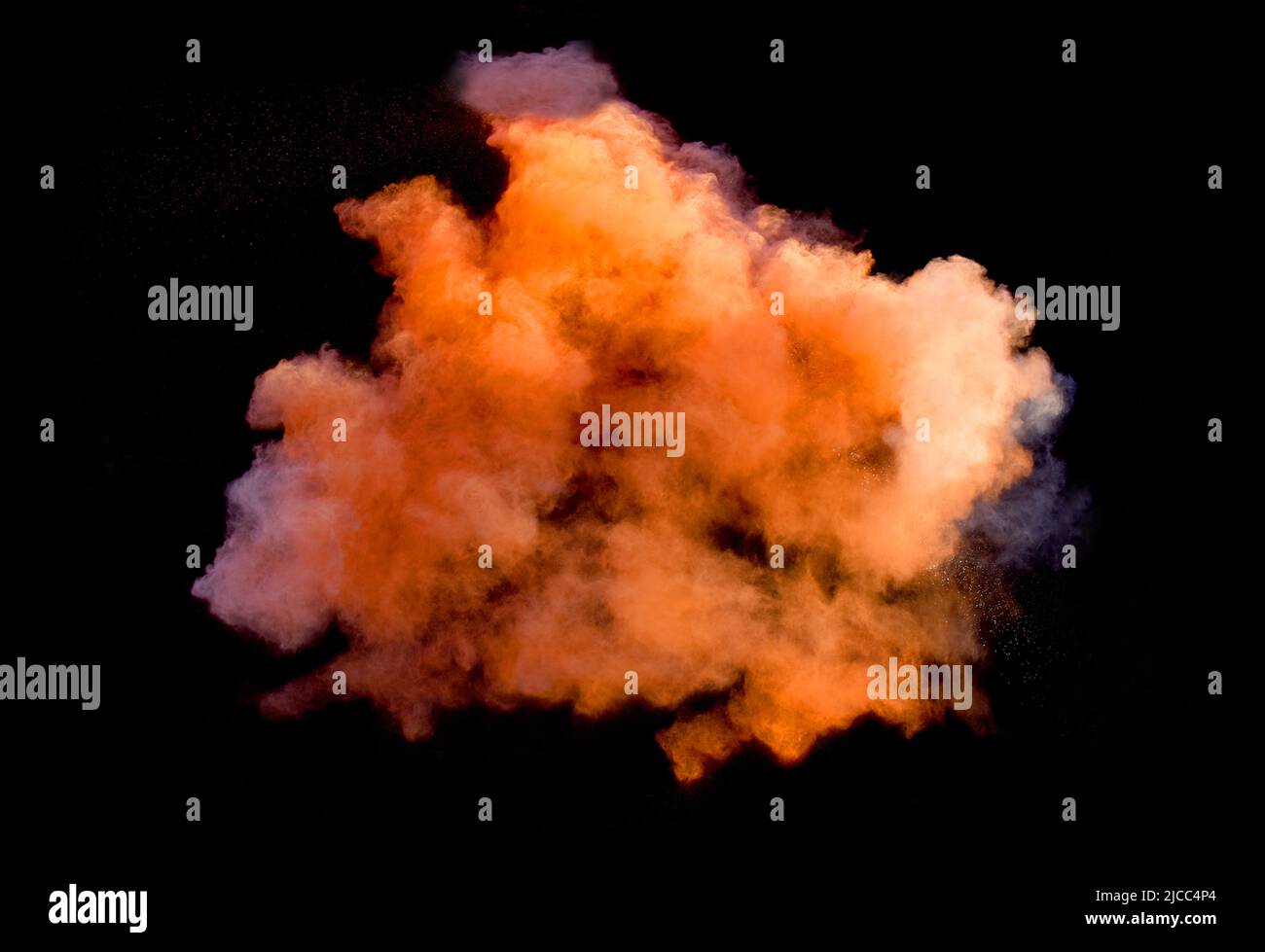 Vivid multi-coloured forms of powder paint explode in front of a black ...