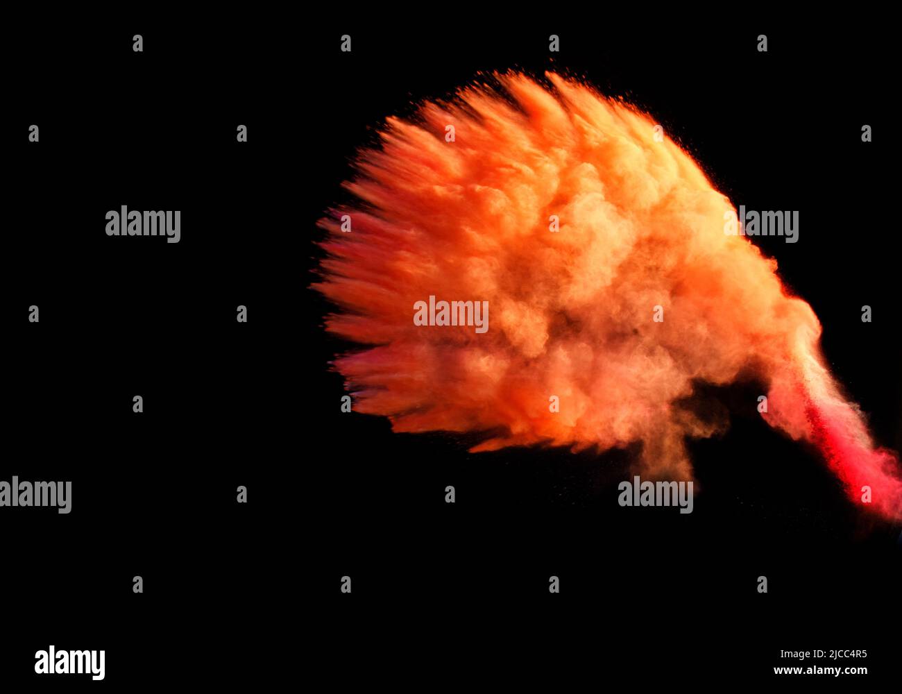 Vivid multi-coloured forms of powder paint explode in front of a black ...