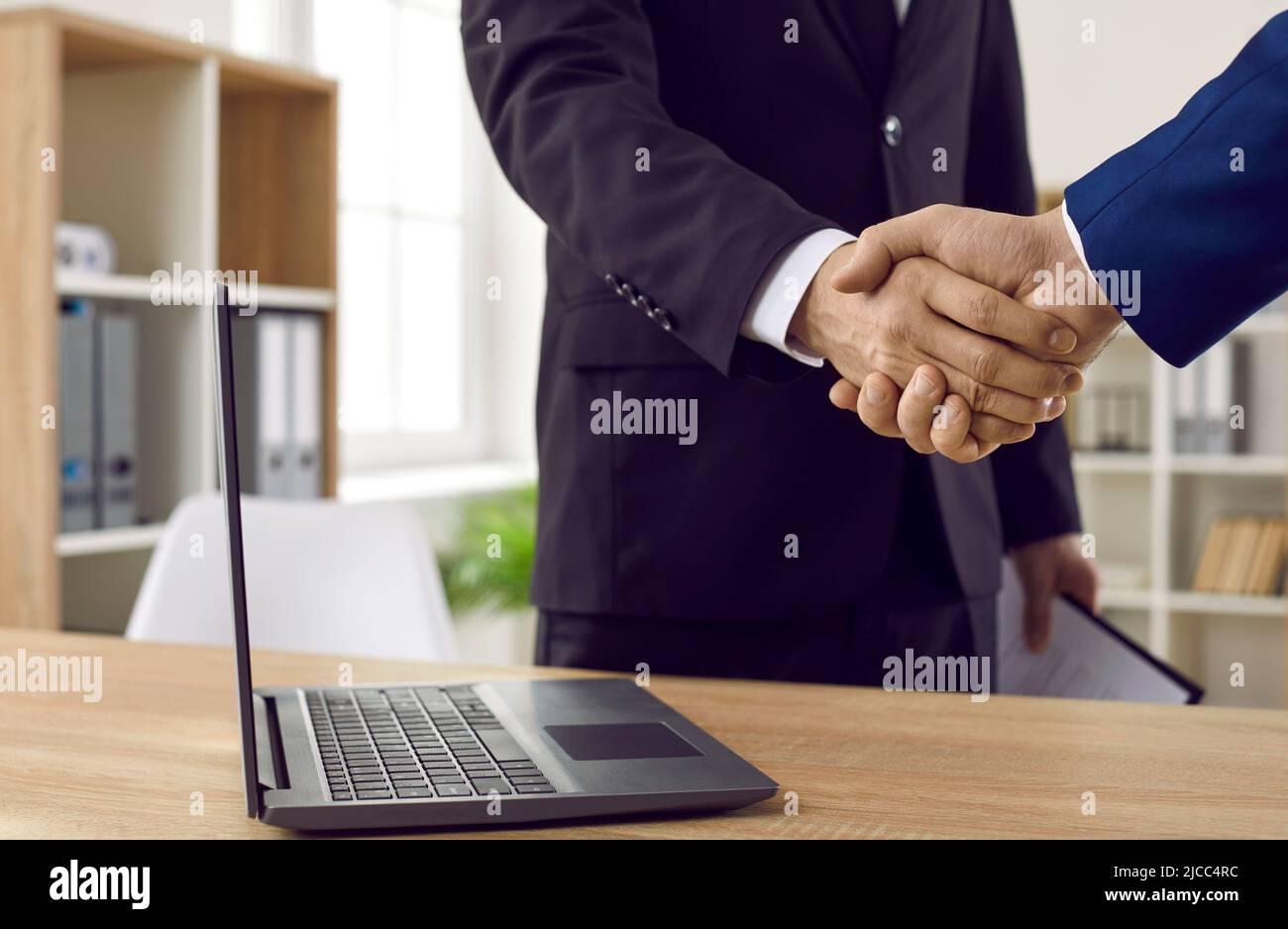 Two male entrepreneurs meet in the office, make a business deal and ...