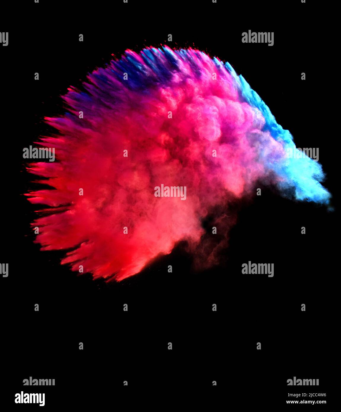 Vivid multi-coloured forms of powder paint explode in front of a black ...