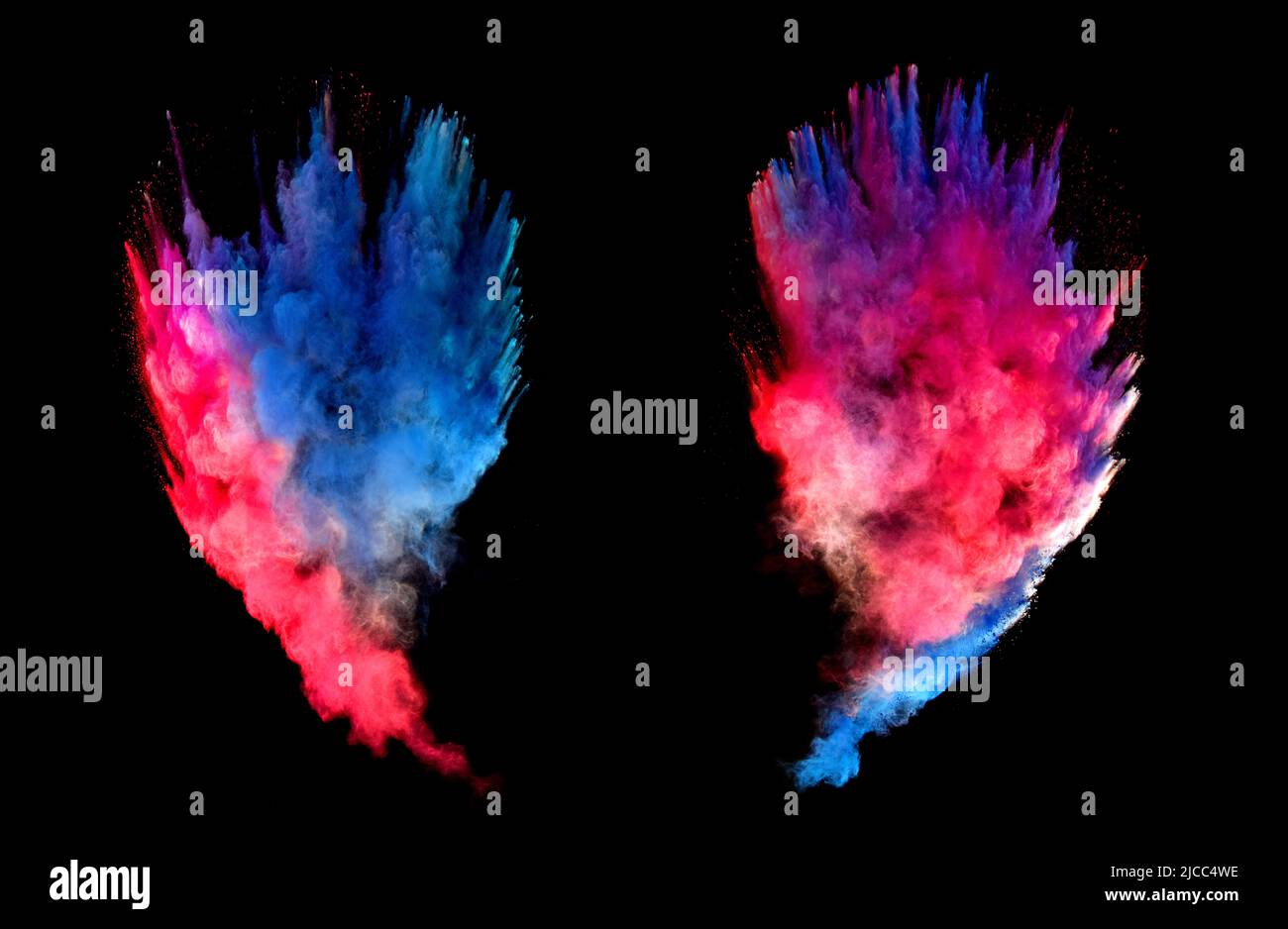 Vivid multi-coloured forms of powder paint explode in front of a black ...