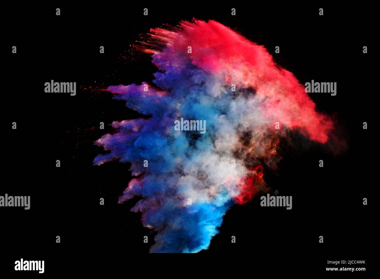 Vivid multi-coloured forms of powder paint explode in front of a black ...