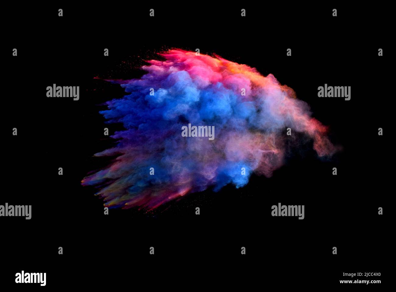 Vivid multi-coloured forms of powder paint explode in front of a black ...