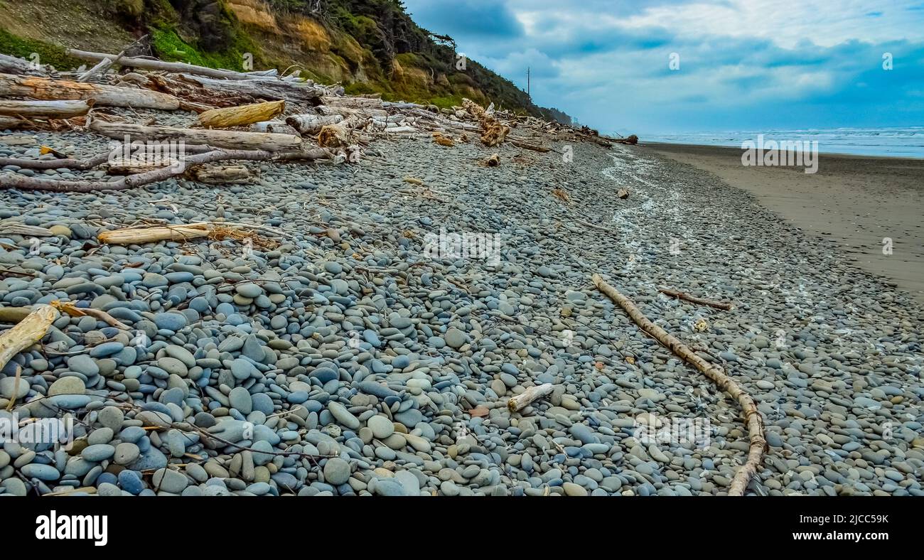 Round colored stones on the wide shore of the Pacific Ocean in Olympic ...