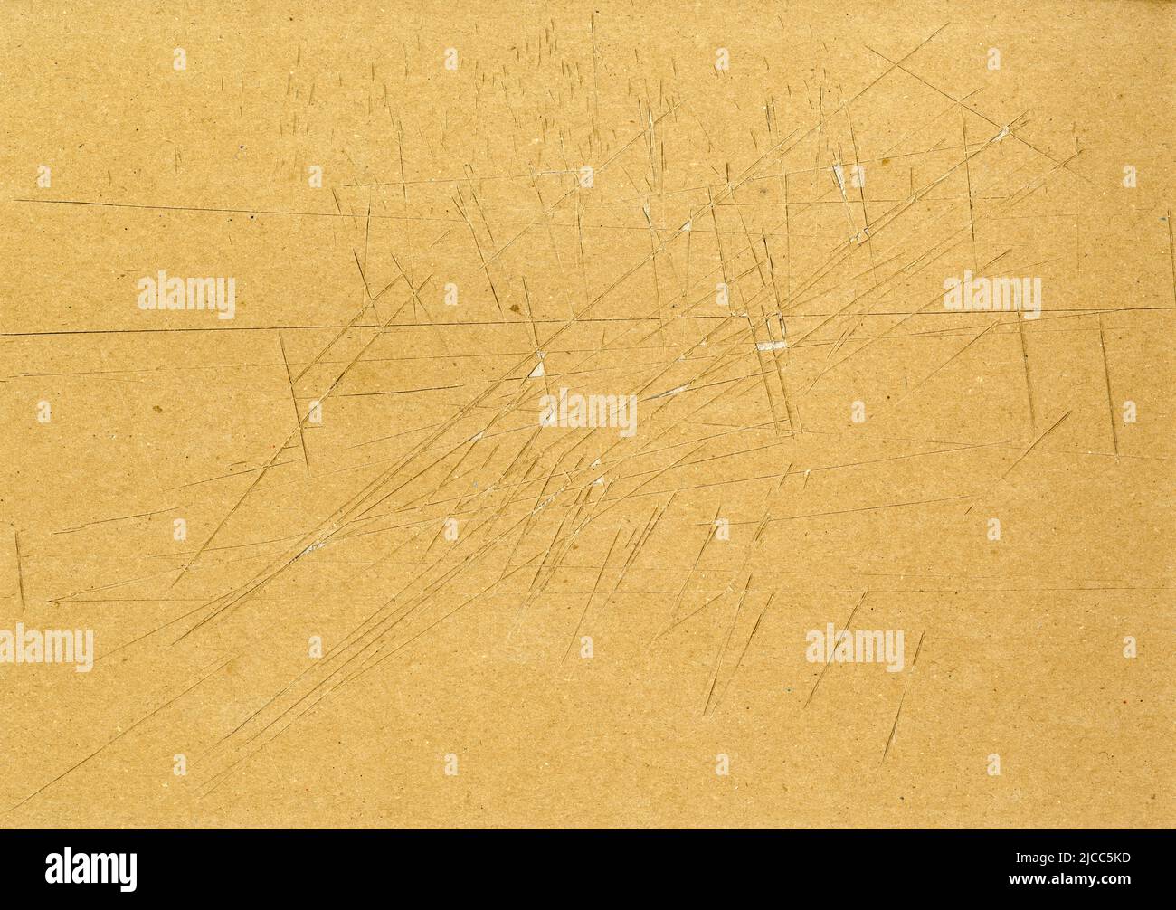 Highly detailed brown paper board texture with many knife cut marks and ...