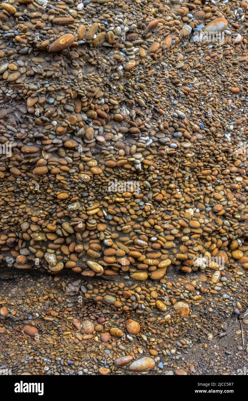 Clumping oval stones are washed away by water ashore in Olympic ...