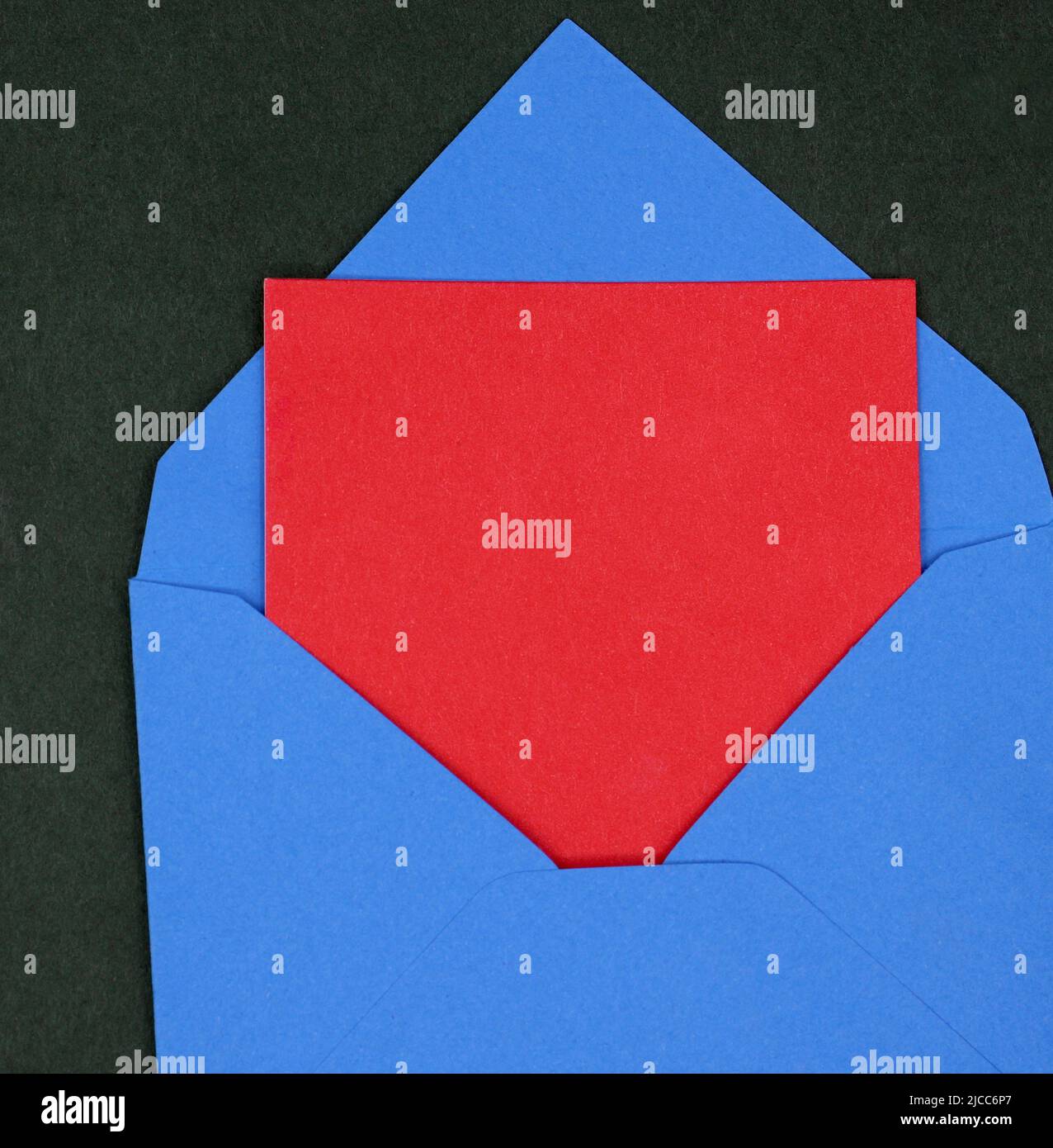 Red note paper in blue envelope Stock Photo - Alamy