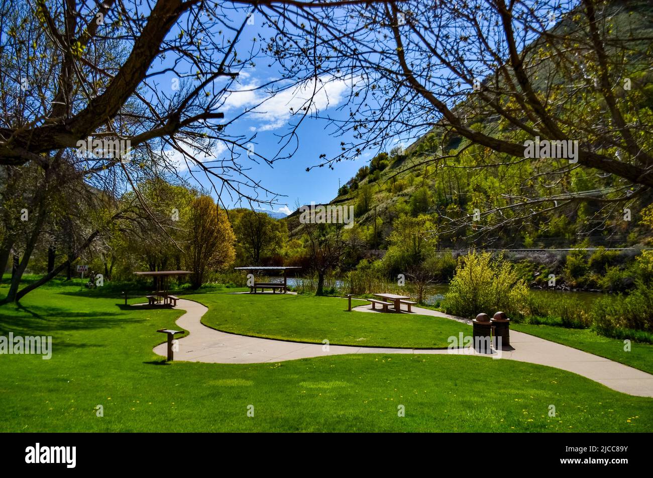 Table and benches in a recreation area near a small river in Utah, USA ...