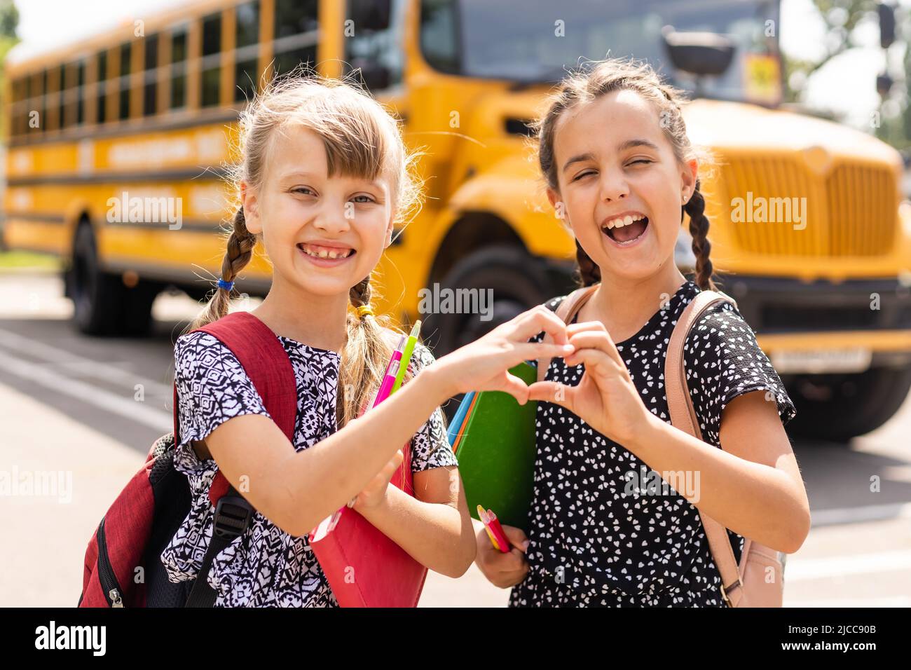 Education: Smiling Student Friends Ready For School next to school bus ...