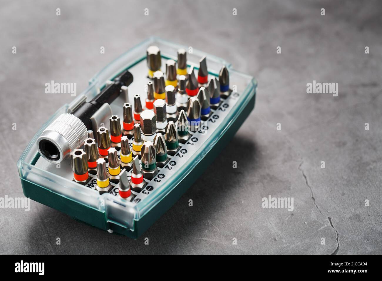 A set of metal bits for screwdrivers in a box. Hexagon head of ...