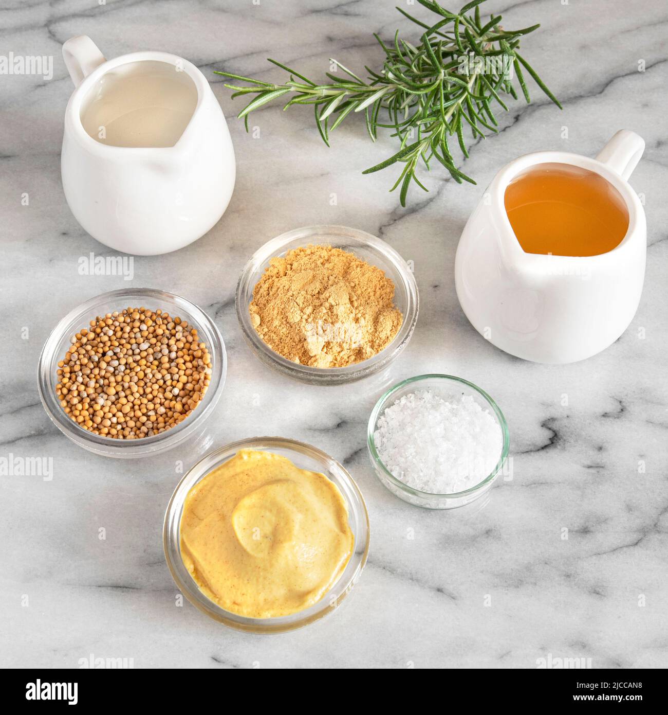 Close-up of mustard seeds and yellow mustard in glass bowls Stock Photo ...
