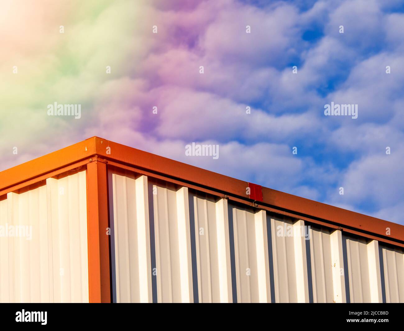 Warehouse in steel construction under blue sky and sun rays Stock Photo ...