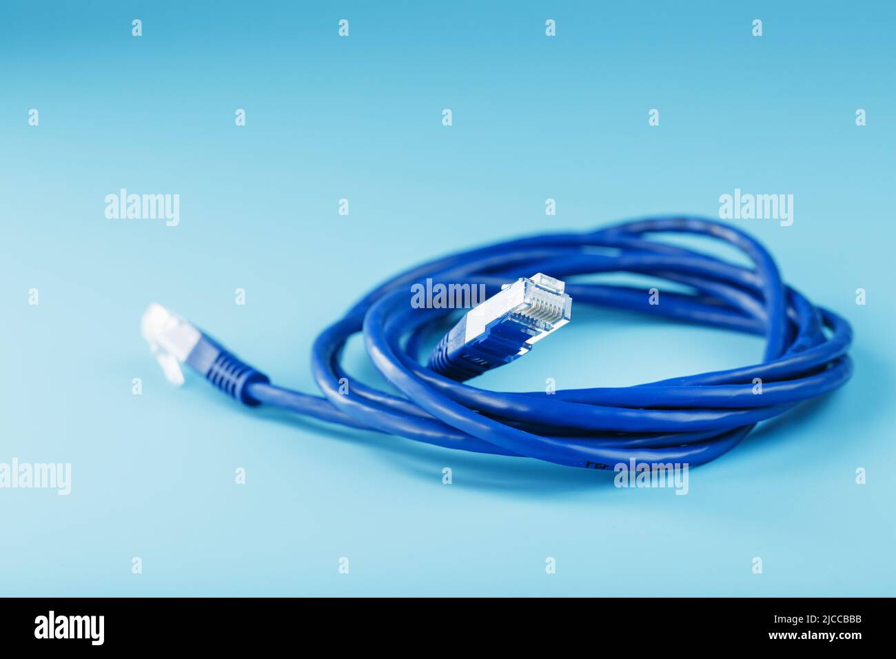 Blue UTP Internet Cable - Isolated on a blue background Ethernet Cord ...