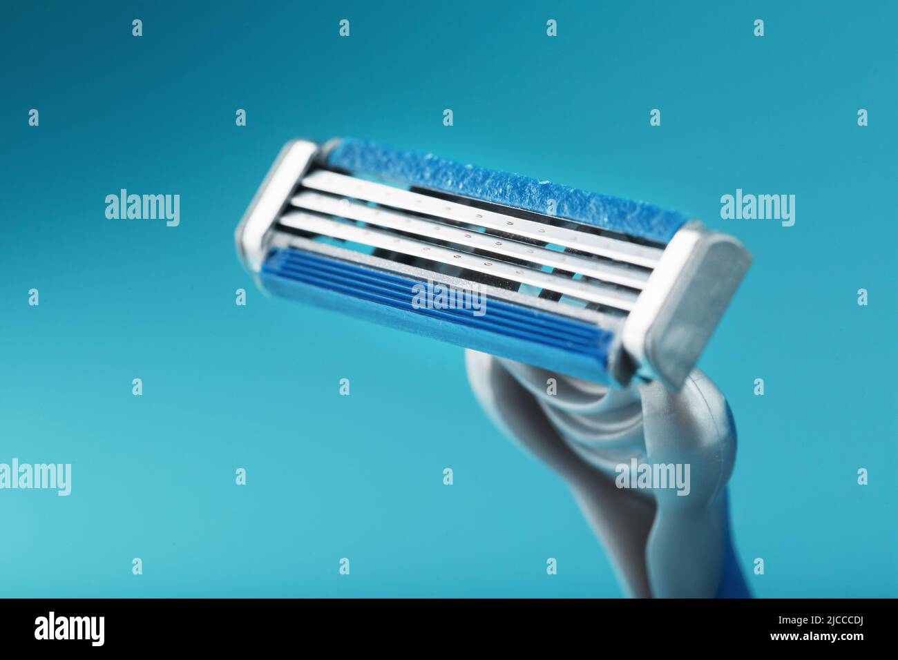 Three shaving machines on a blue background with free space, top view ...