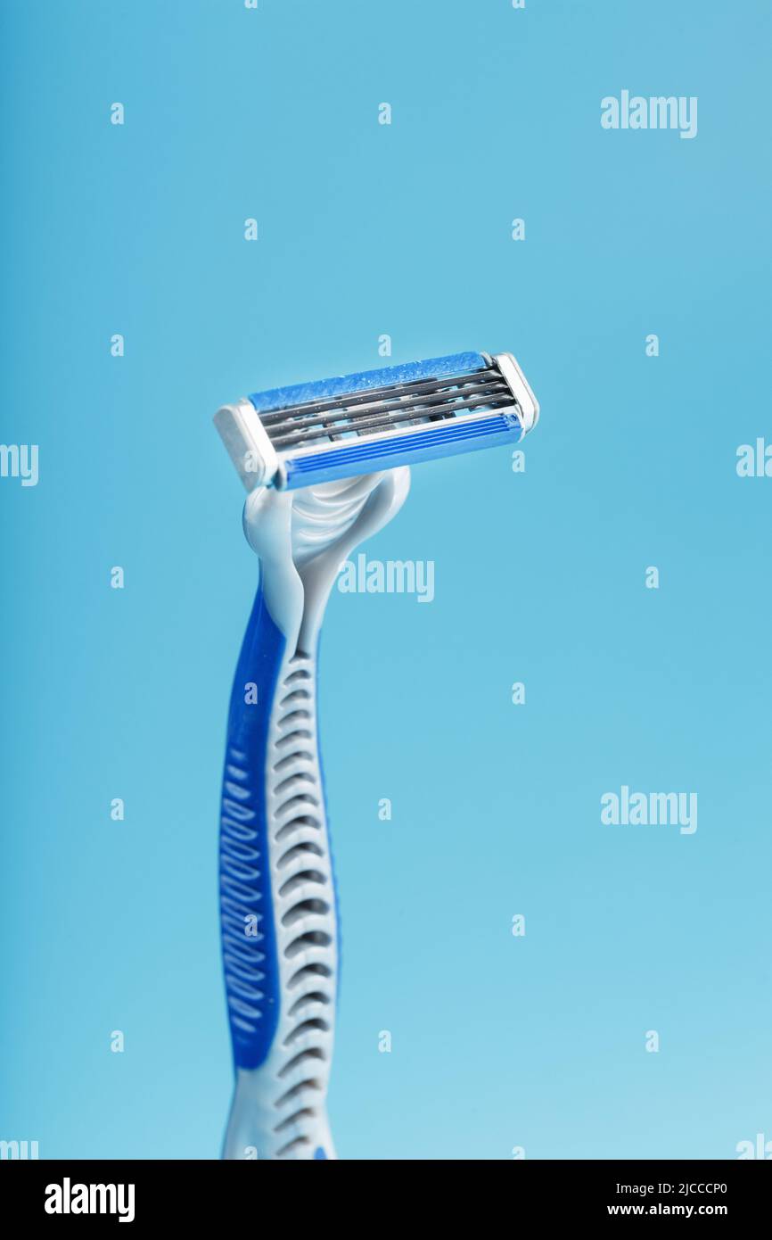 Blades of a new shaving machine on a blue background close-up free ...