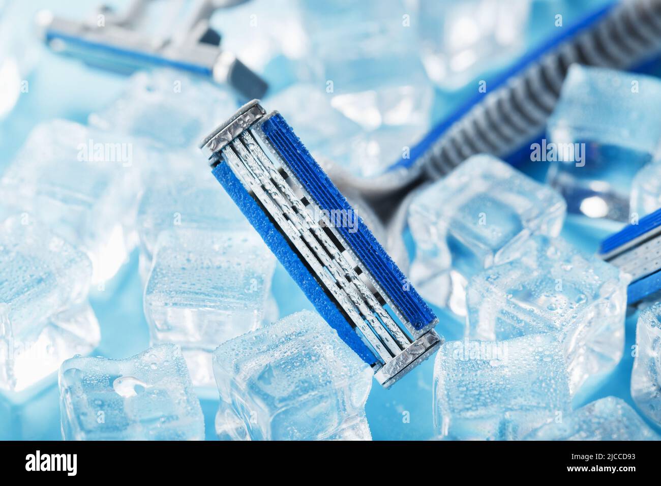 Shaving machine on a blue background with ice cubes. The concept of ...