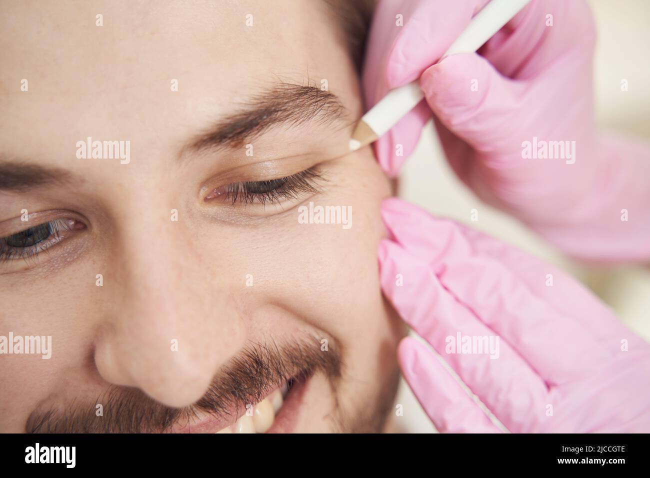 Contour marking of man eye with white pencil Stock Photo - Alamy