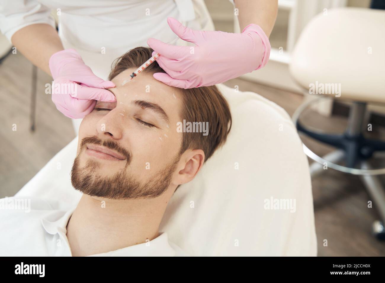 Botulinum toxin head skin treatment of pleased male patient Stock Photo ...